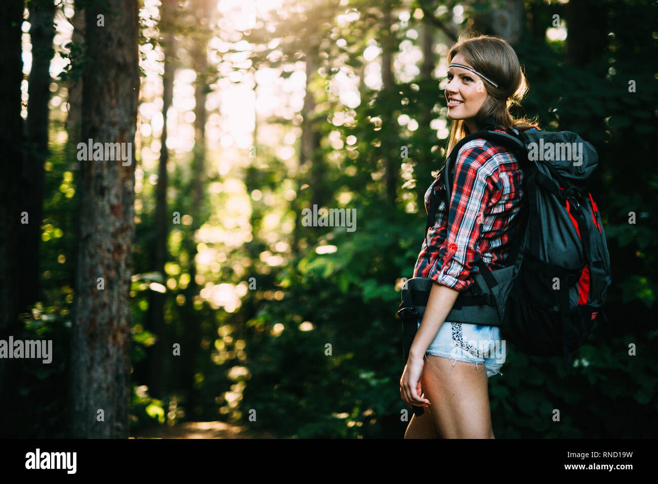 Female backpacker set out on forest trail Stock Photo - Alamy