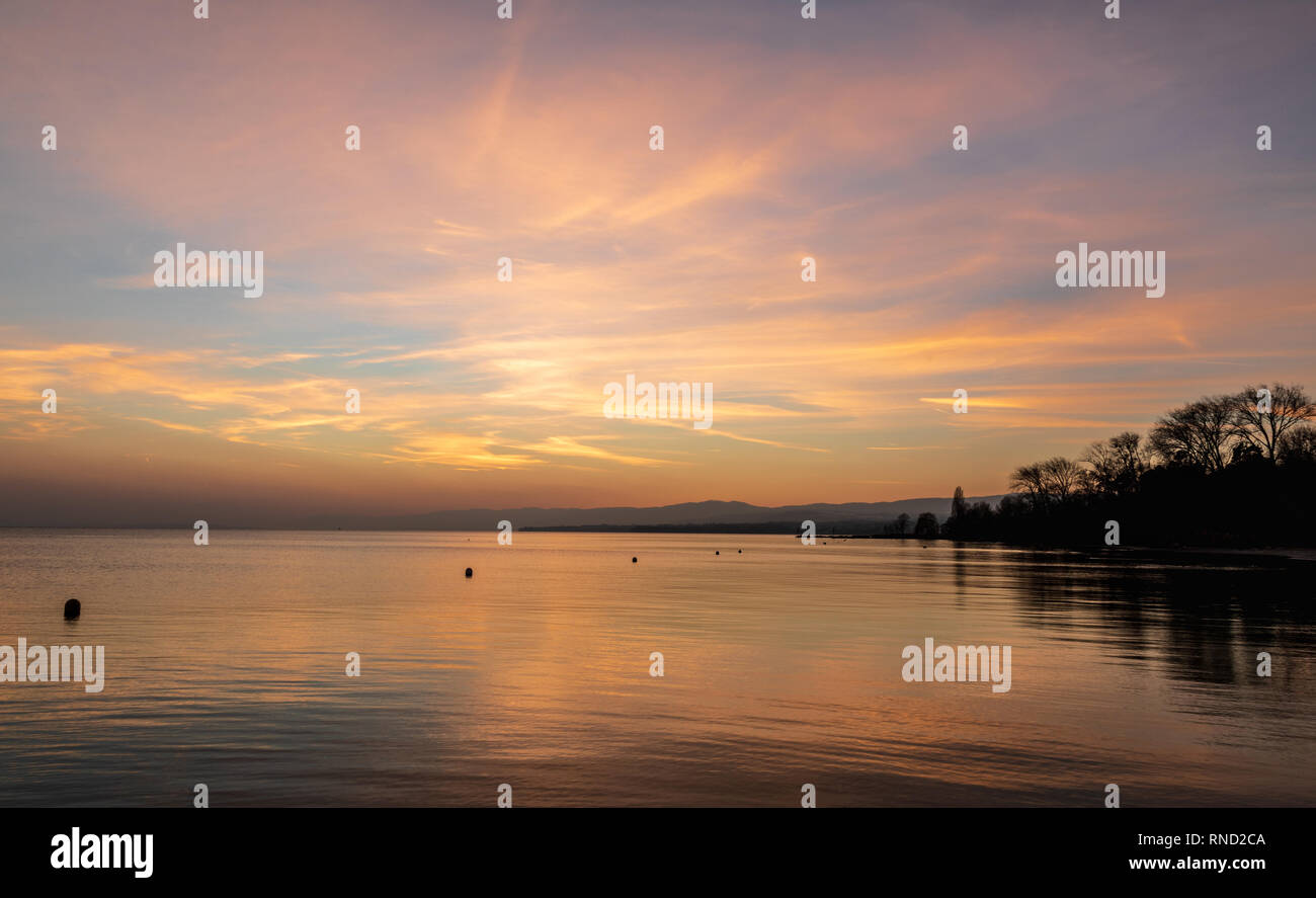 Beautiful colorful sunset sky with clouds over the lake Leman. Lausanne ...
