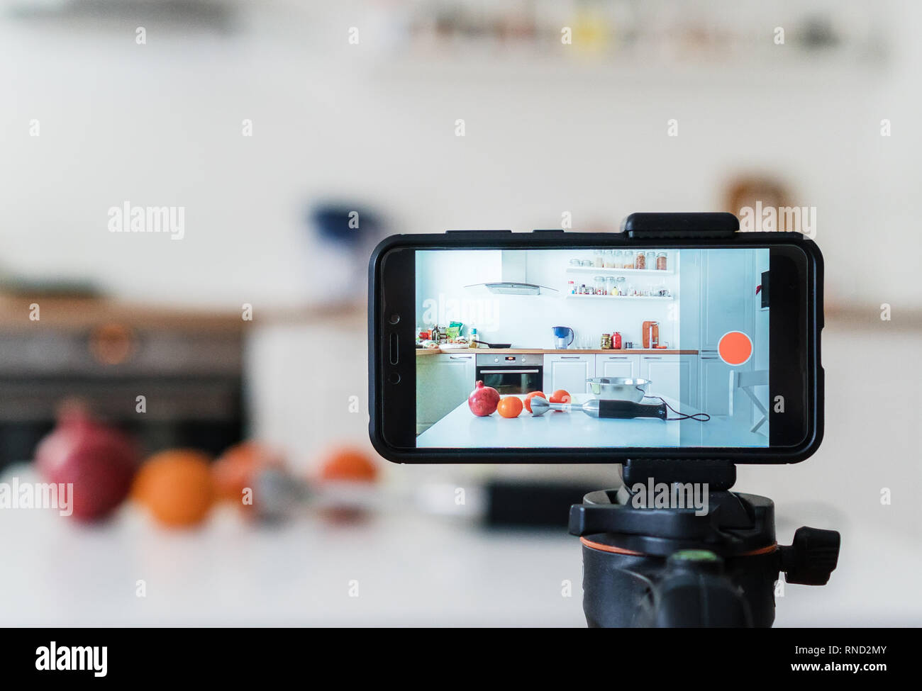 Phone camera on tripod in kitchen. Vlogging concept Stock Photo - Alamy