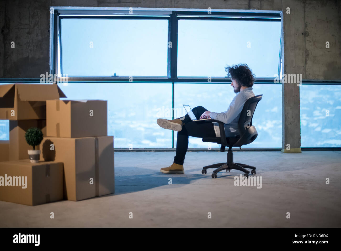 young male architect on construction site checking documents and ...
