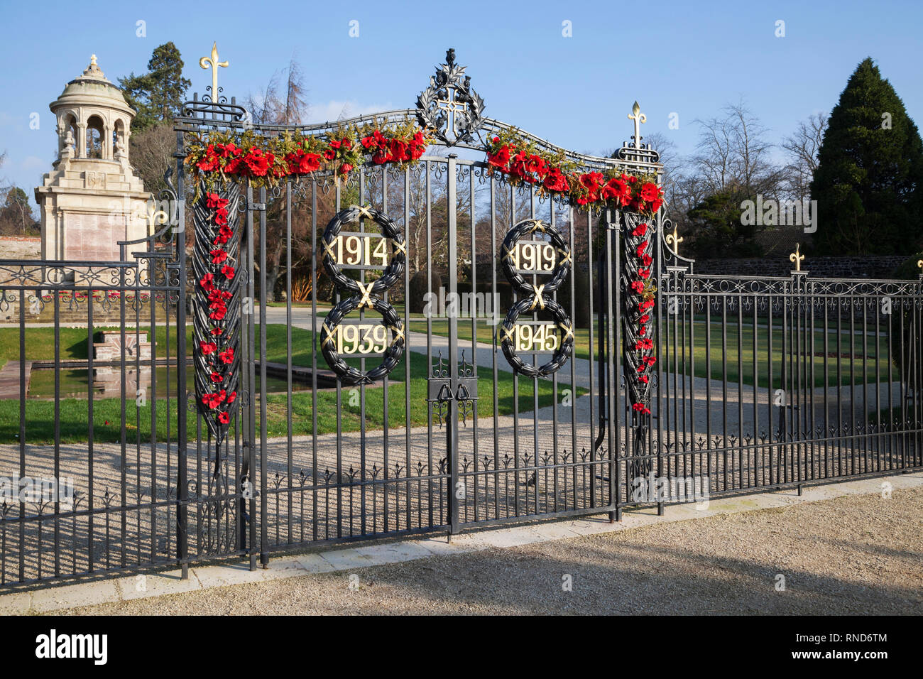 The war memorial gates with red poppies and dates of first and second ...