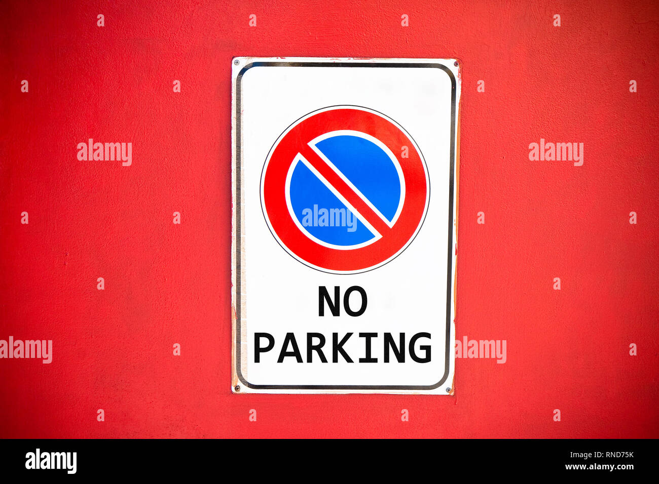 No parking warning sign on red background Stock Photo - Alamy