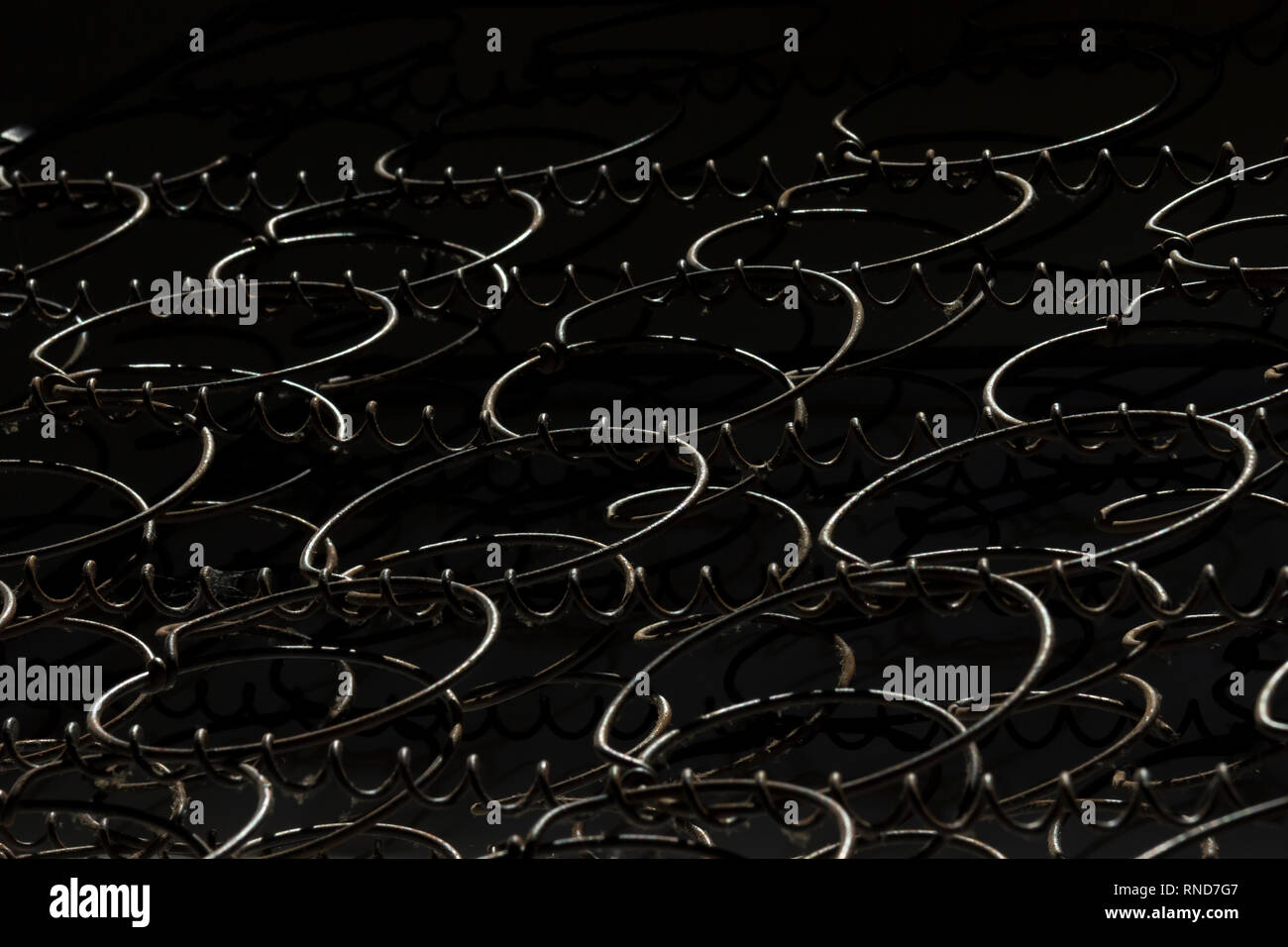 Detail of an old structure of a rusty spring mattress. Abstract ...