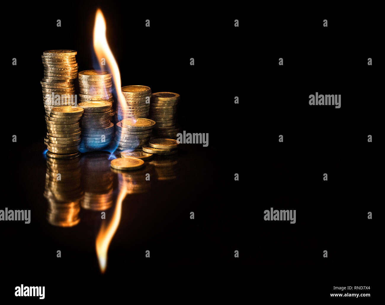 Euro coin with fire flames Stock Photo - Alamy