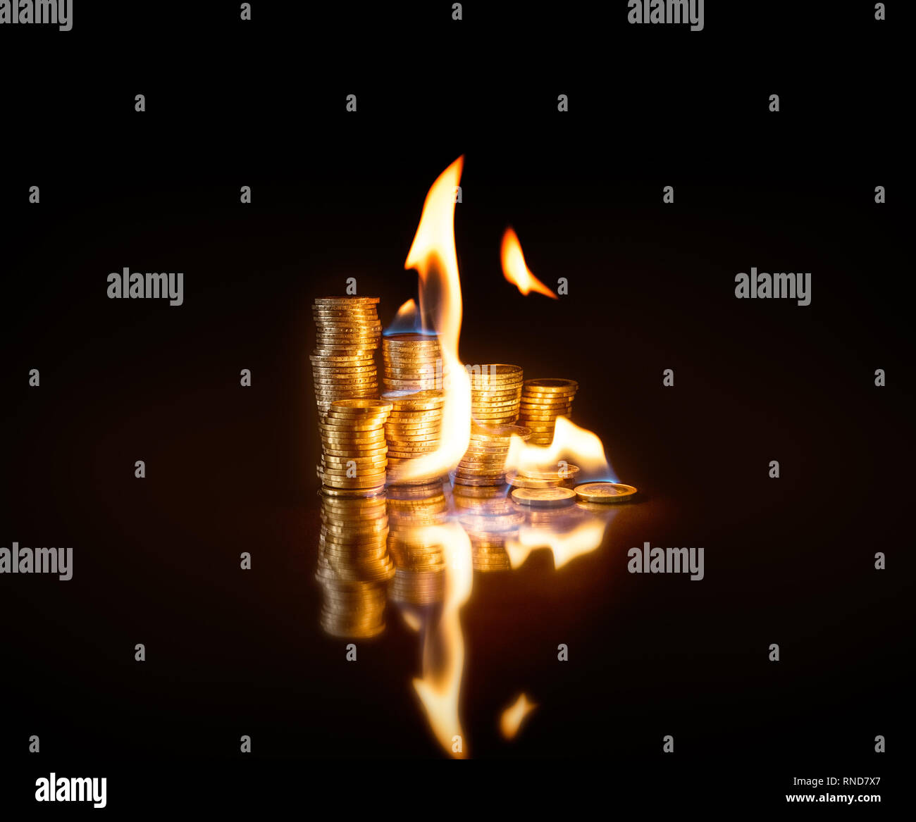 Euro coin with fire flames Stock Photo - Alamy
