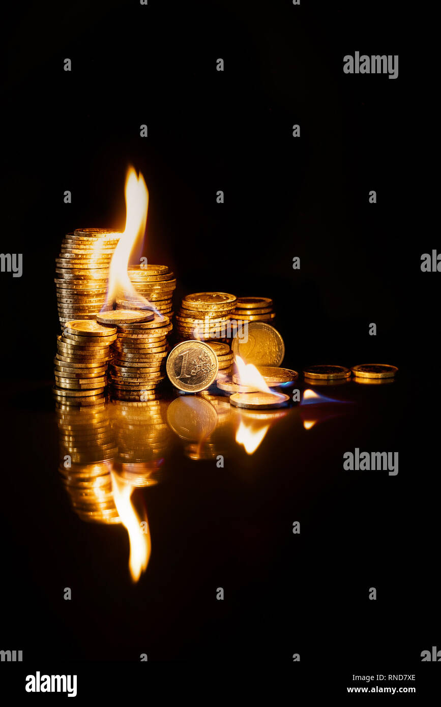 Euro coin with fire flames Stock Photo - Alamy