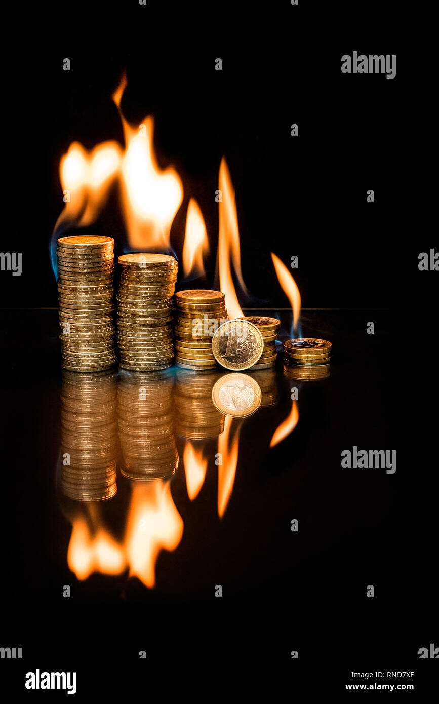 Euro coin with fire flames Stock Photo - Alamy