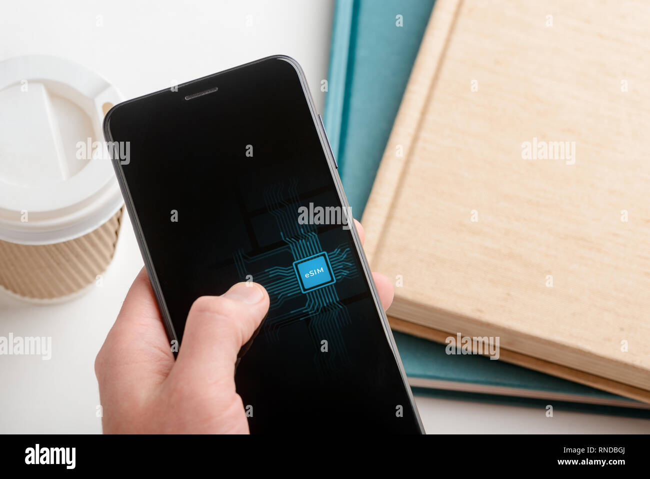 Cell phone with e-SIM chip Stock Photo - Alamy