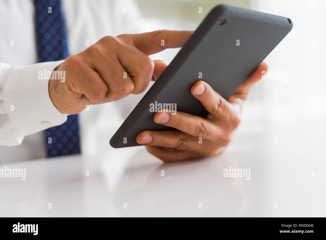 Old hands using tablet close hi-res stock photography and images - Alamy