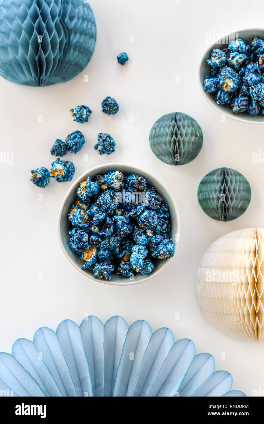 Blueberry popcorn on bowls and blue paper decorations Stock Photo - Alamy