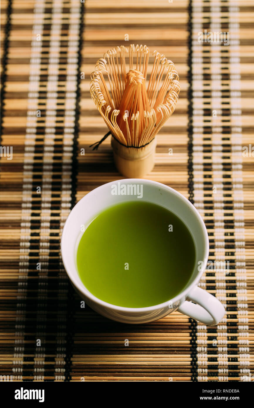 Preparing matcha tea with bamboo whisk Stock Photo - Alamy