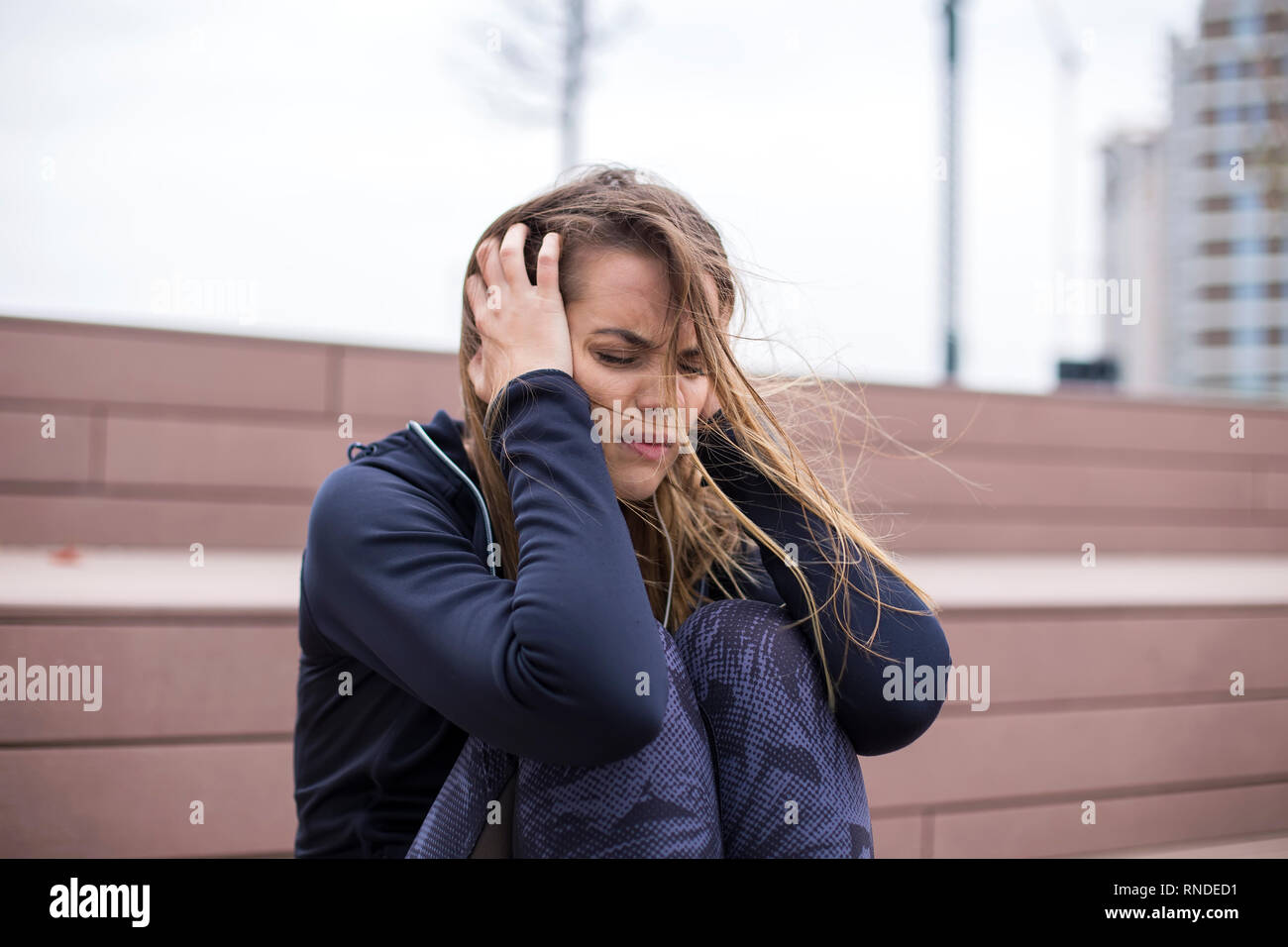 Portrait of angry young woman sitting at outdoor Stock Photo - Alamy