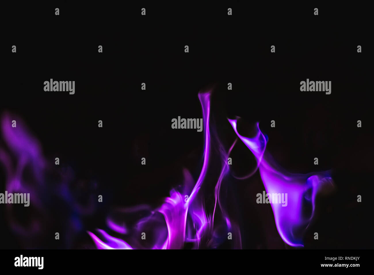 Black background image of purple fire forms Stock Photo - Alamy