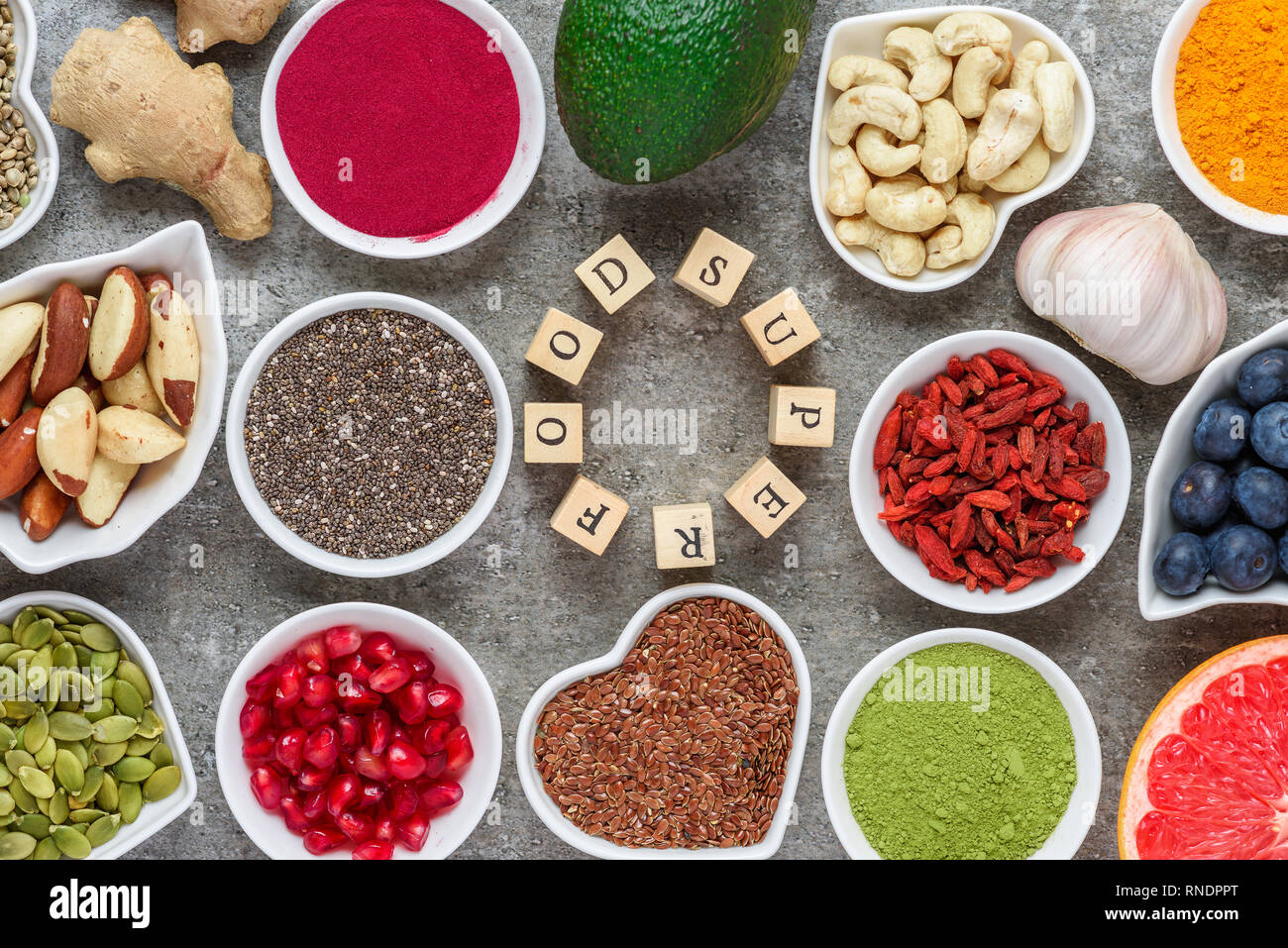 various superfoods on gray background. matcha, acai, turmeric, fruits ...