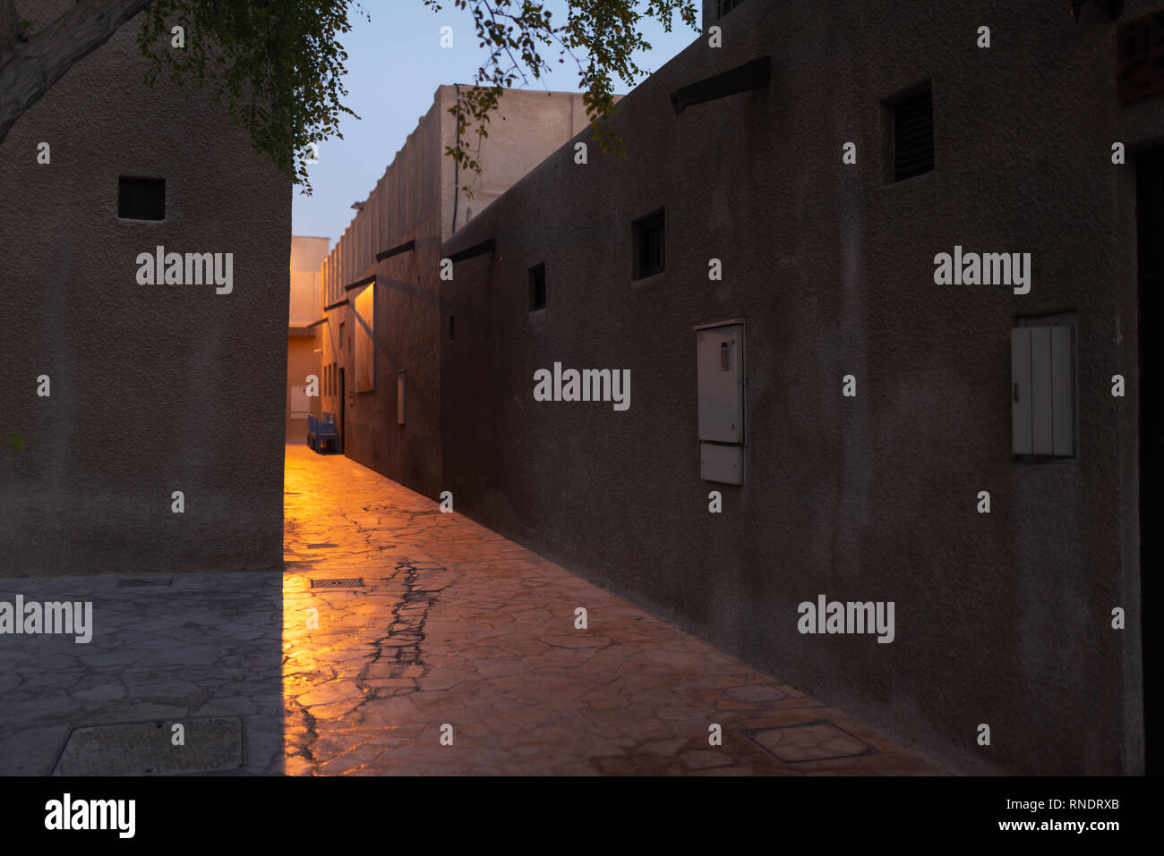 Mysterious street with yellow lighting in Al Fahidi Historical District ...