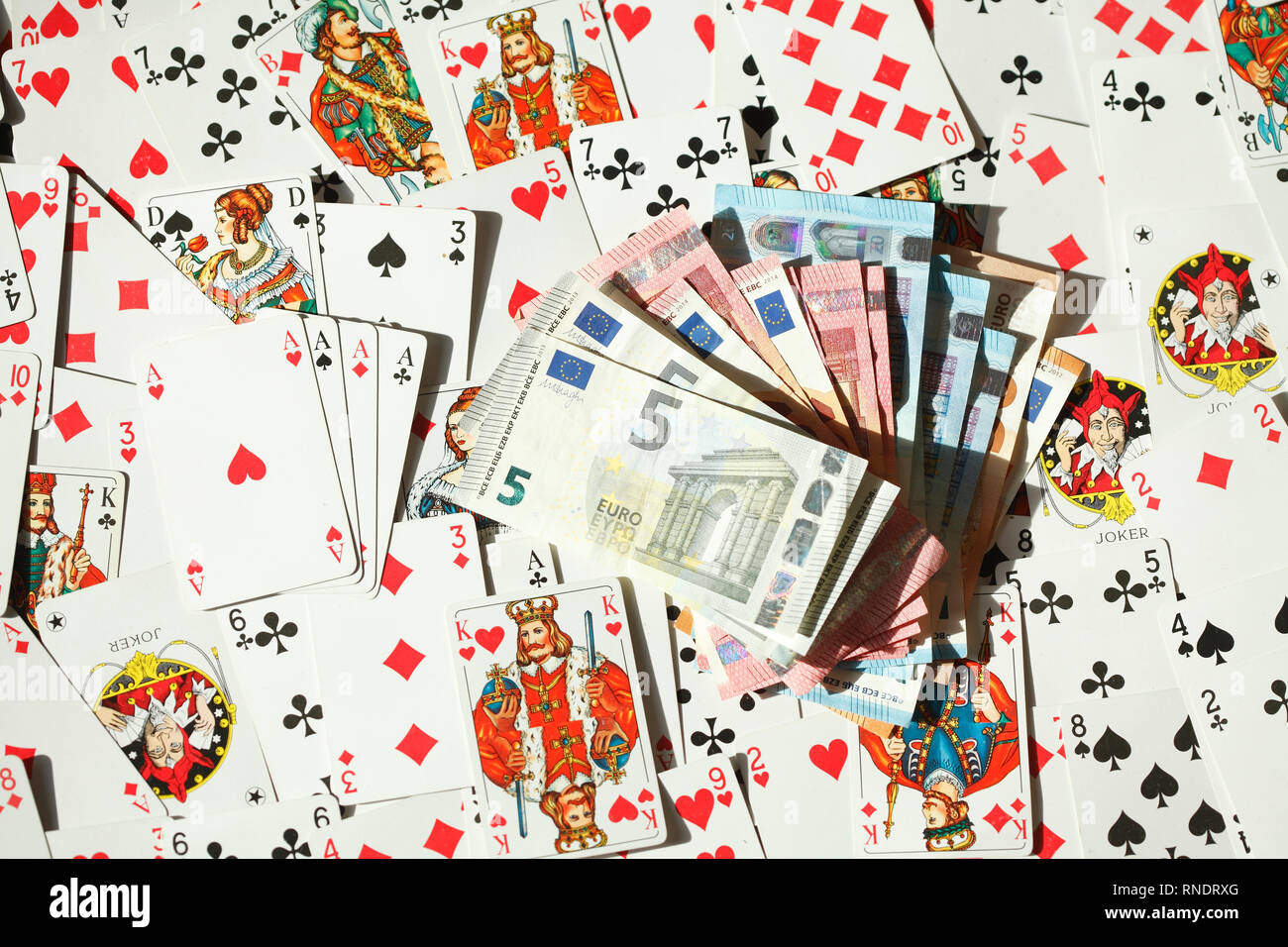 Four aces, various colorful playing cards, euro banknotes, background ...
