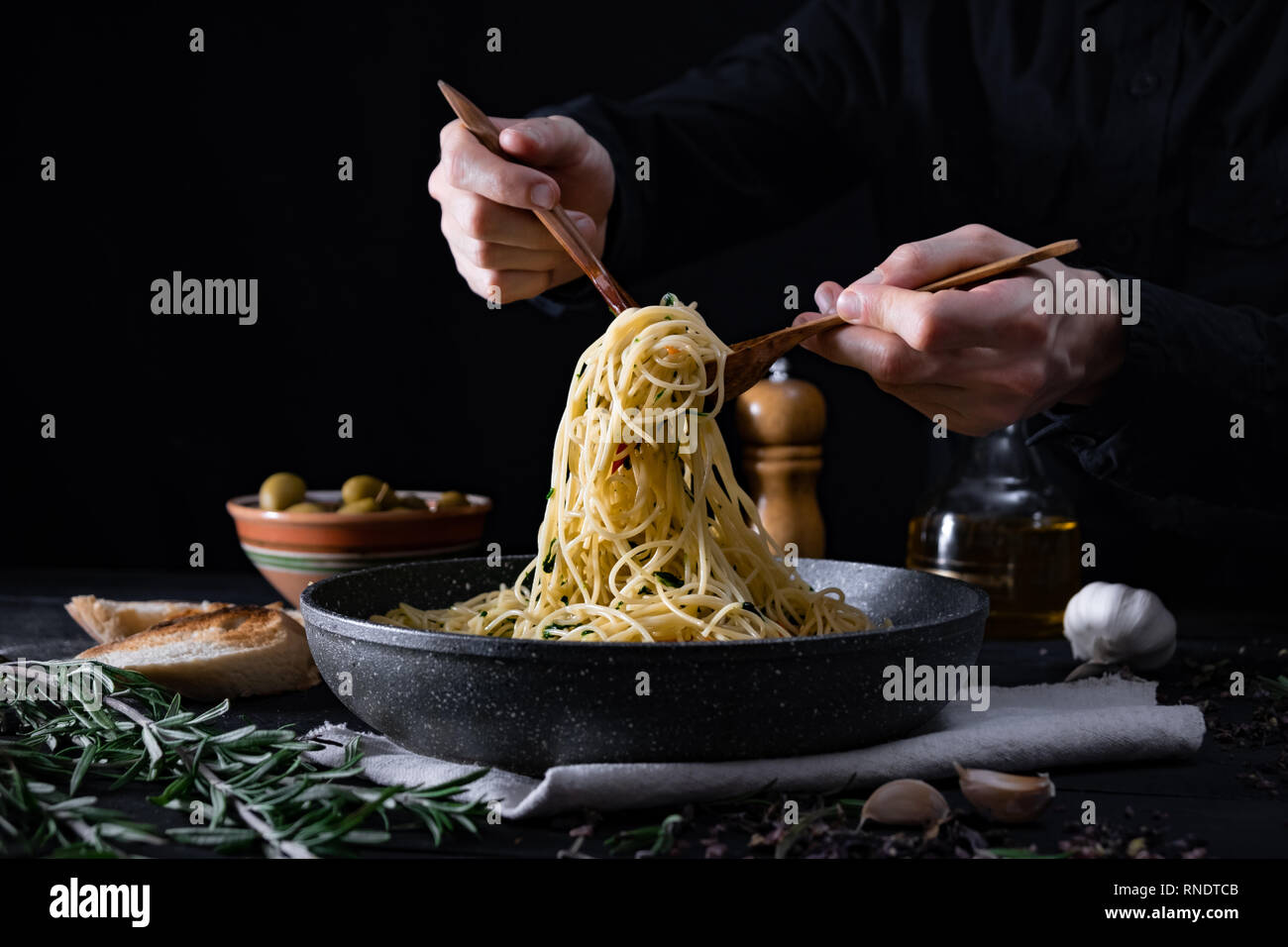 Serving traditional italian pasta from a pan. Male hands taking ...