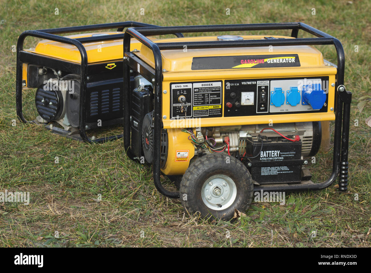 yellow petrol portable generator on wheels, close-up, emergency Stock ...