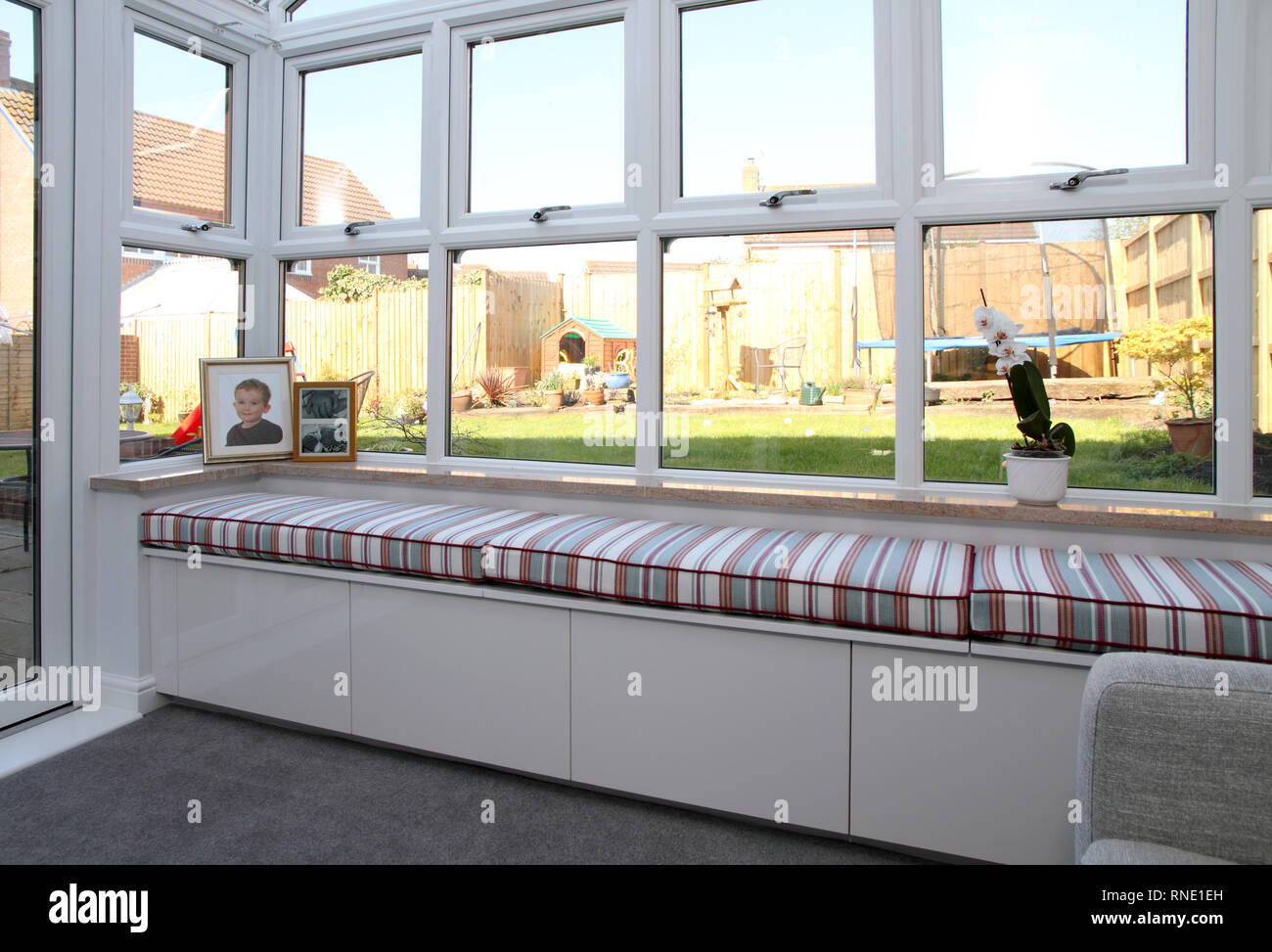 Living room with window seat with underneath storage Stock Photo - Alamy