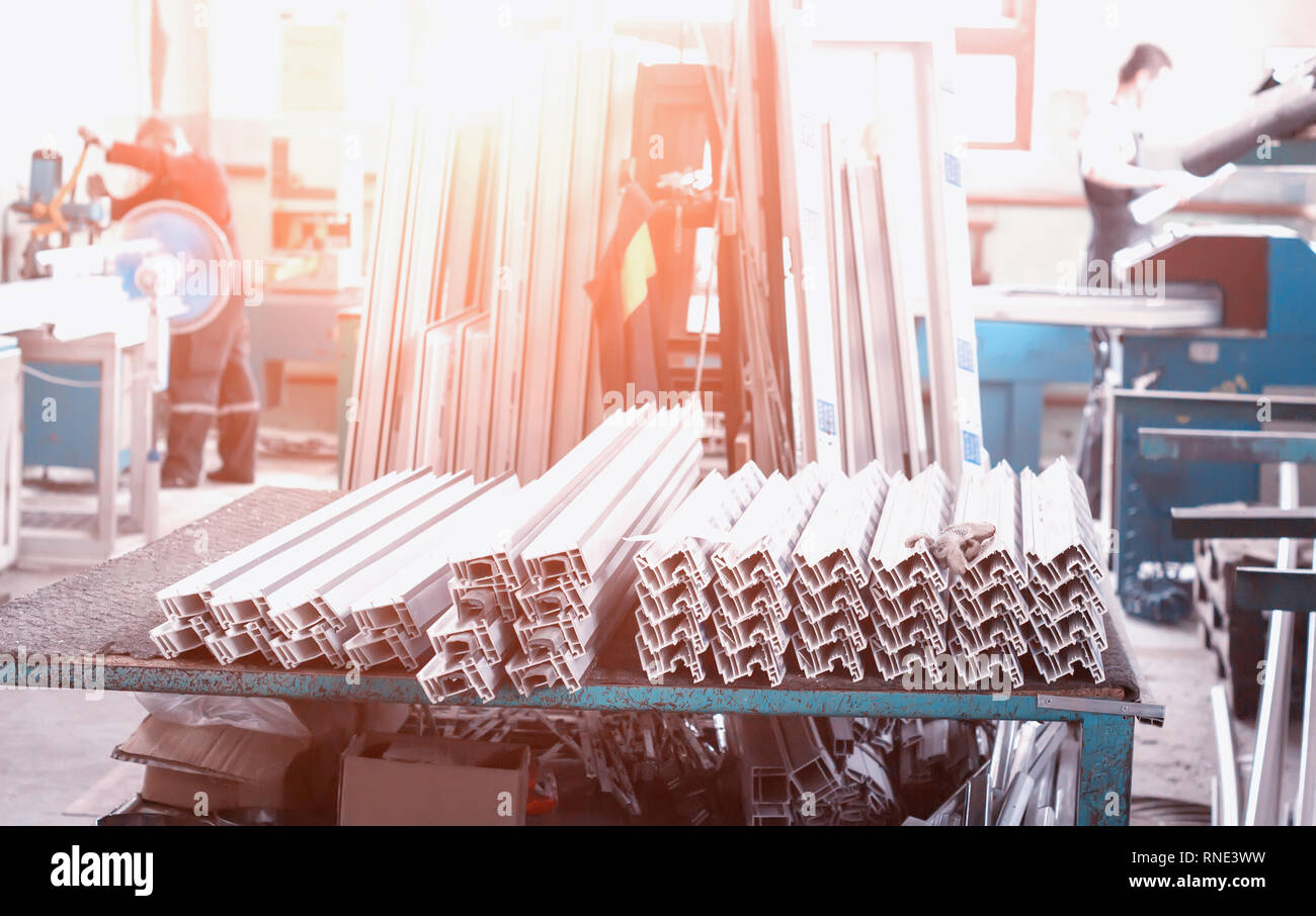 Production of pvc windows, workers in the workshop collect frames and ...
