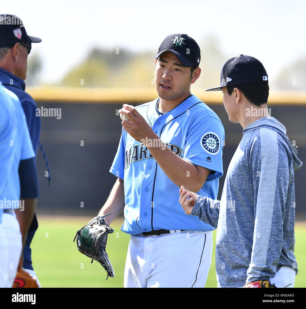 Seattle Mariners pitcher Yusei Kikuchi talks with his interpreter ...
