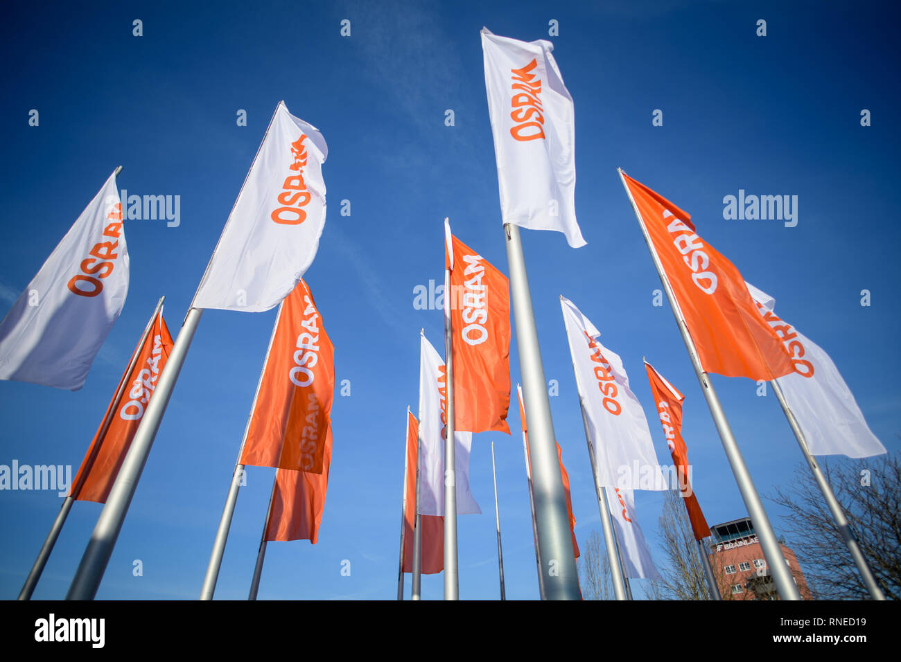 19 February 2019, Bavaria, München: Flags with the Osram logo waft in ...