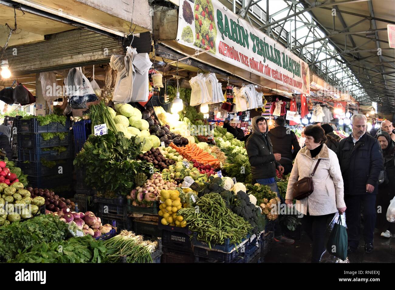 19 February 2019, Turkey, Ankara: Shoppers walk past a produce section ...