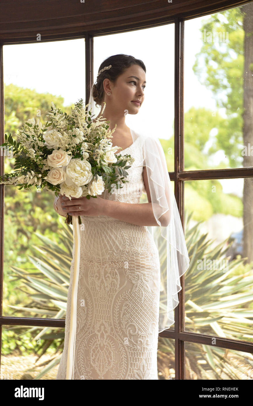 Beautiful white couple get married by the sea on a glorious Summer day ...