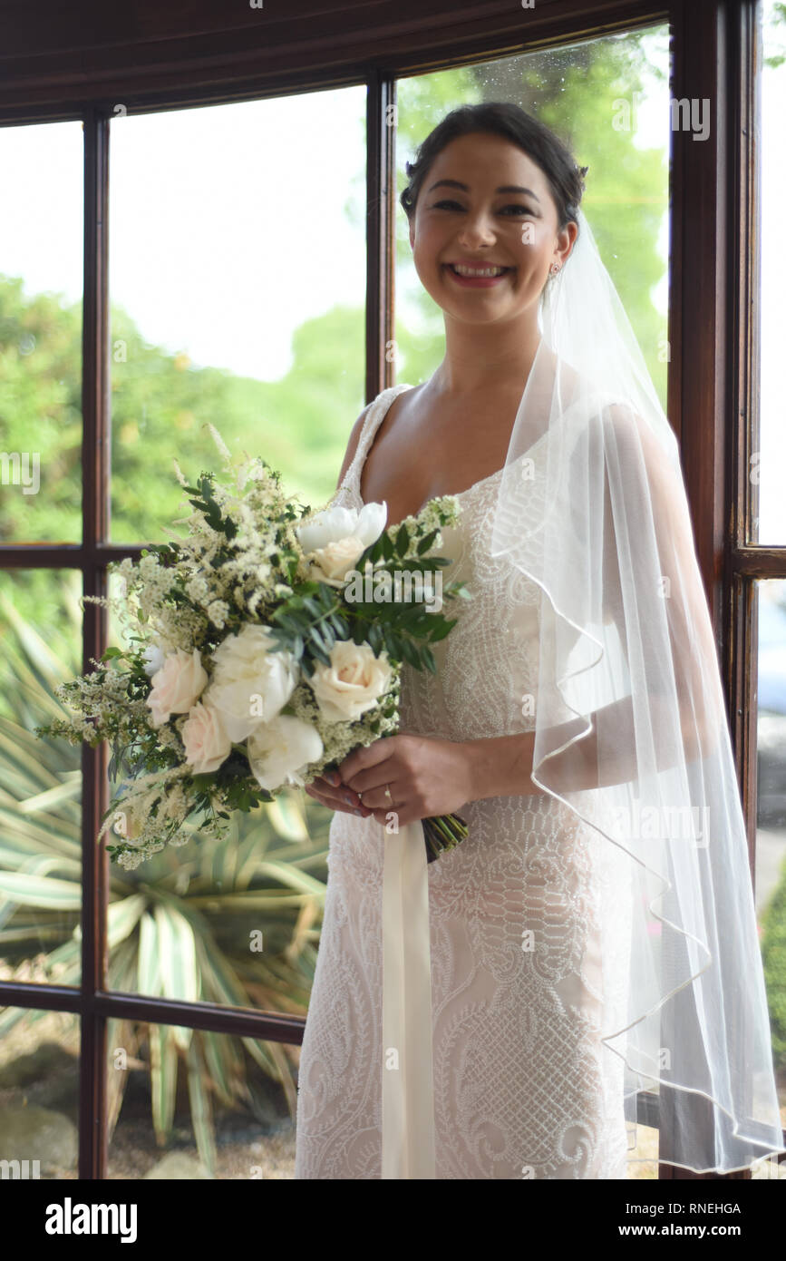 Beautiful white couple get married by the sea on a glorious Summer day ...