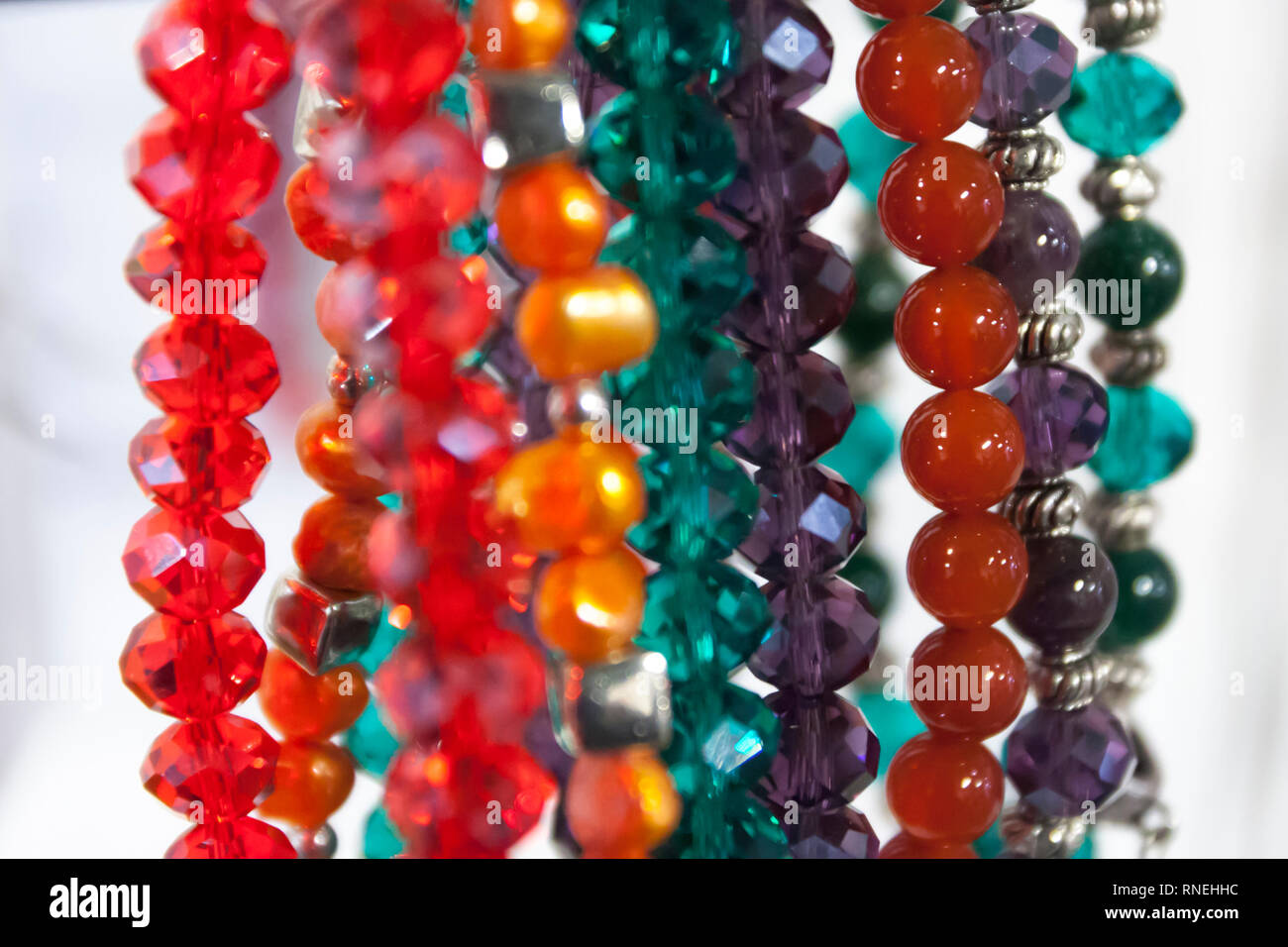 Hanging beautiful colorful bead necklaces in store Stock Photo - Alamy