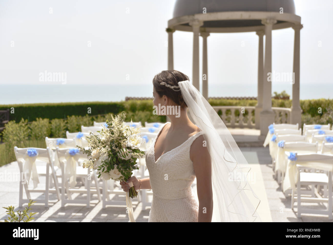 Beautiful white couple get married by the sea on a glorious Summer day ...