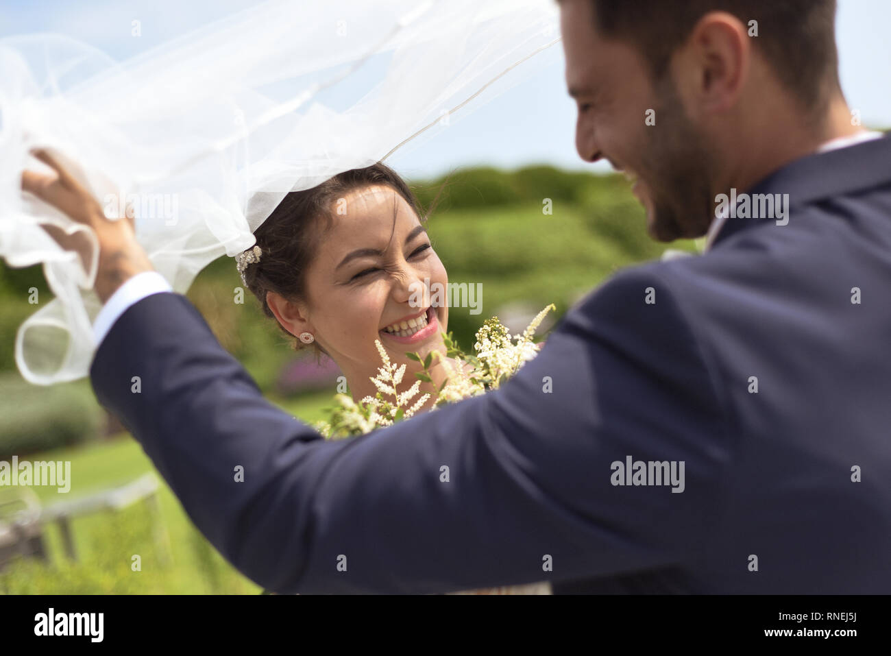 Beautiful white couple get married by the sea on a glorious Summer day ...
