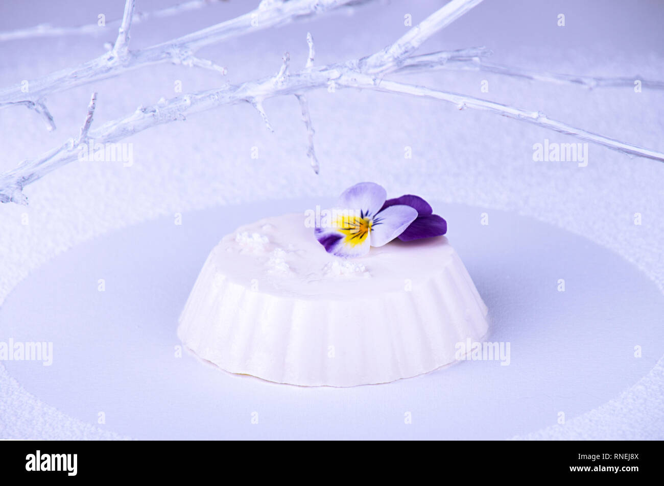 Panna cotta of white cocolate and wipped cream decorated with edible ...