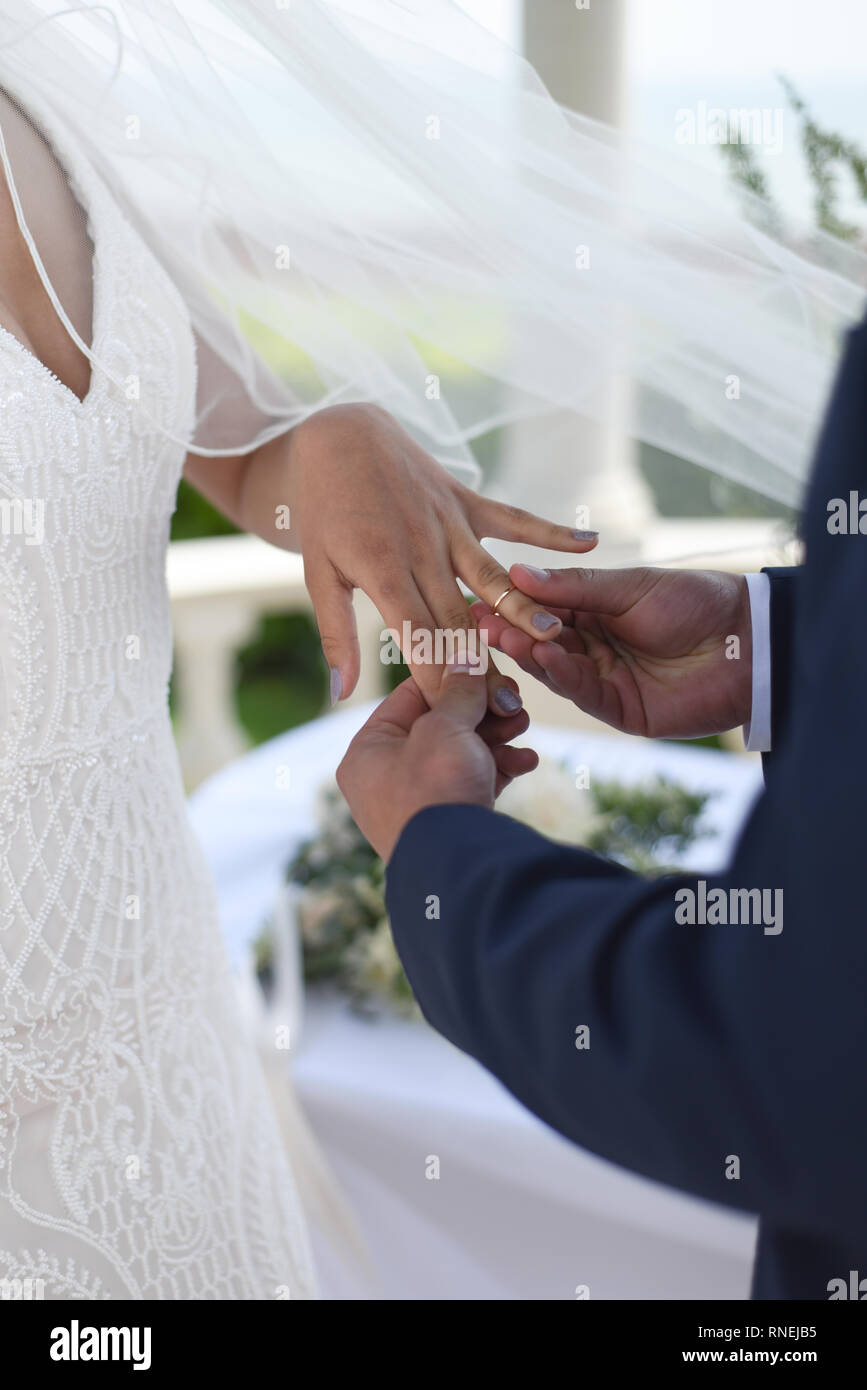 Beautiful white couple get married by the sea on a glorious Summer day ...