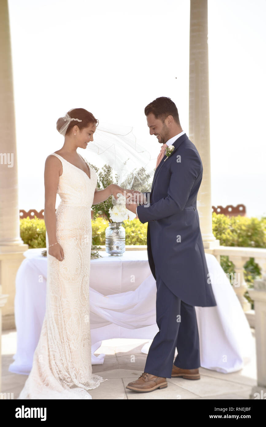 Beautiful white couple get married by the sea on a glorious Summer day ...