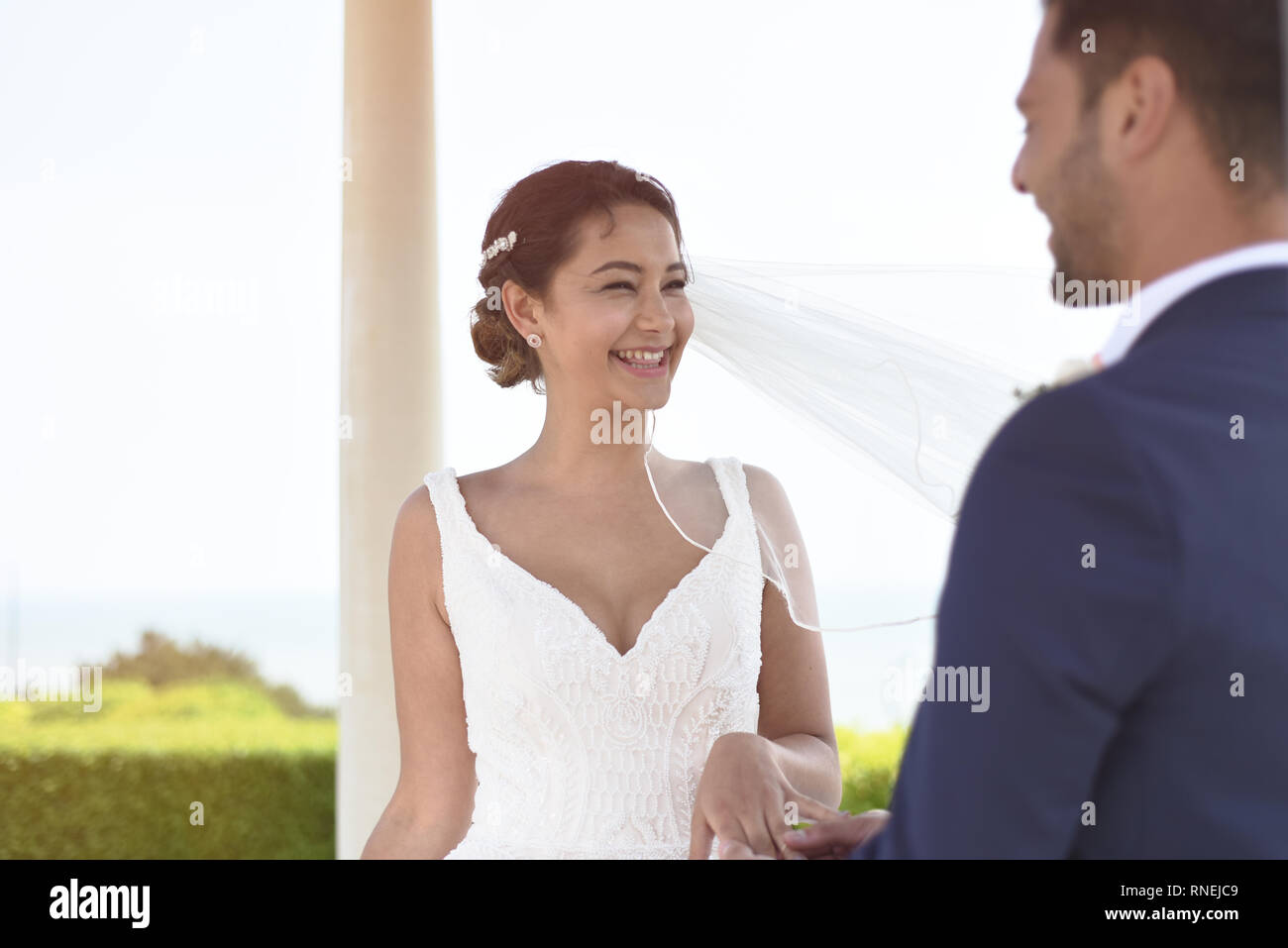 Beautiful white couple get married by the sea on a glorious Summer day ...