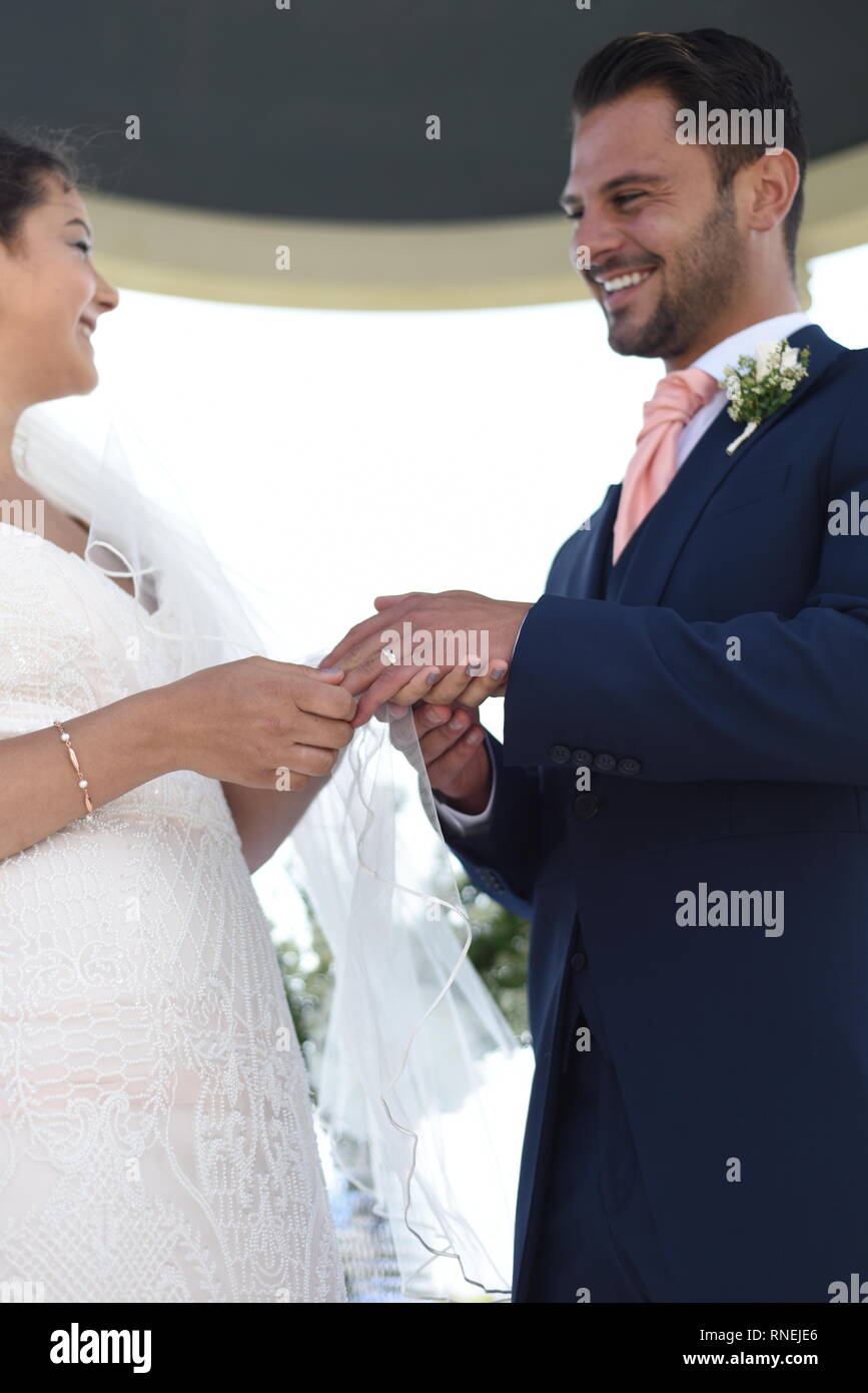 Beautiful white couple get married by the sea on a glorious Summer day ...