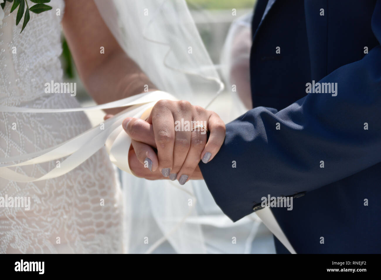 Beautiful white couple get married by the sea on a glorious Summer day ...
