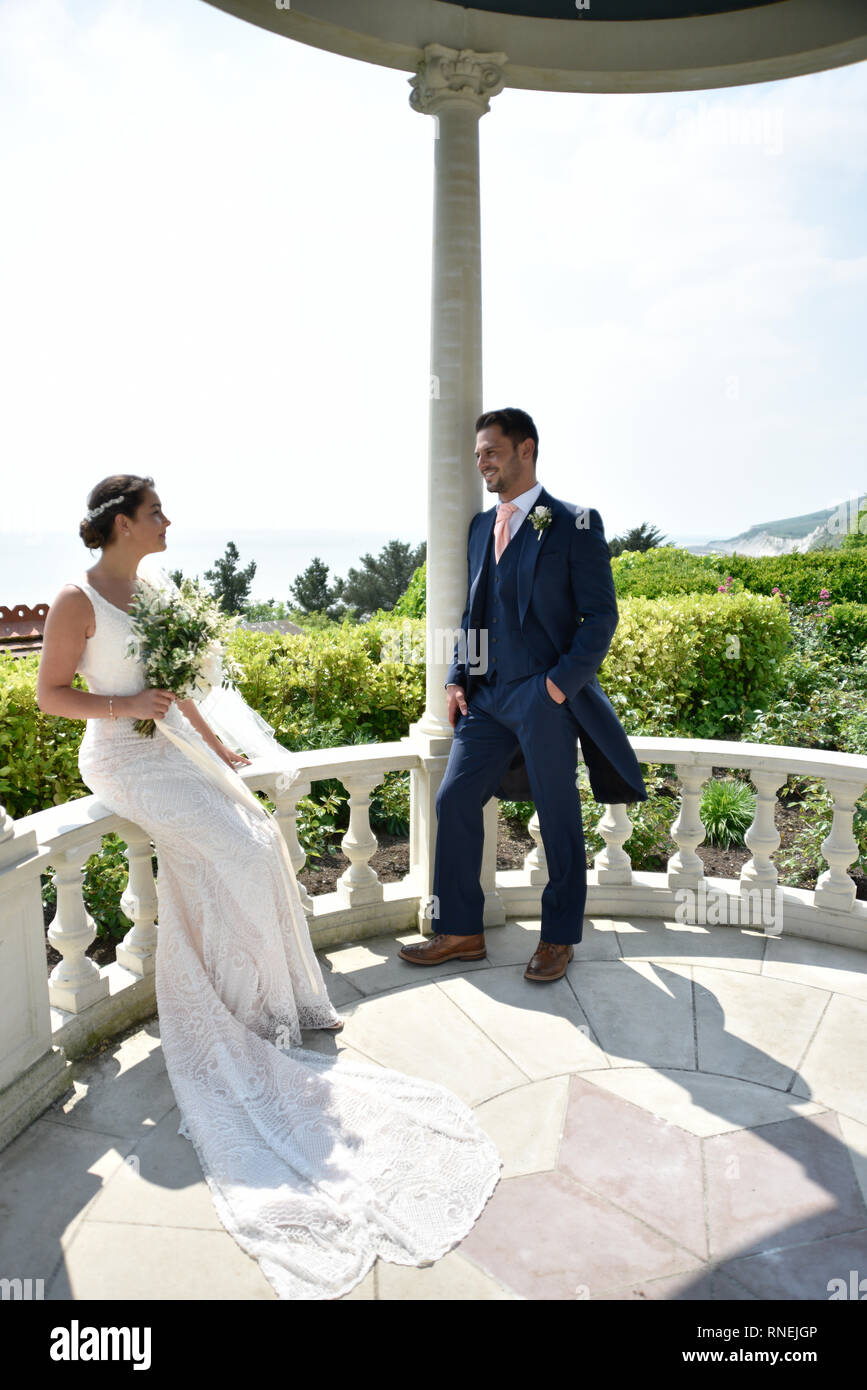 Beautiful white couple get married by the sea on a glorious Summer day ...