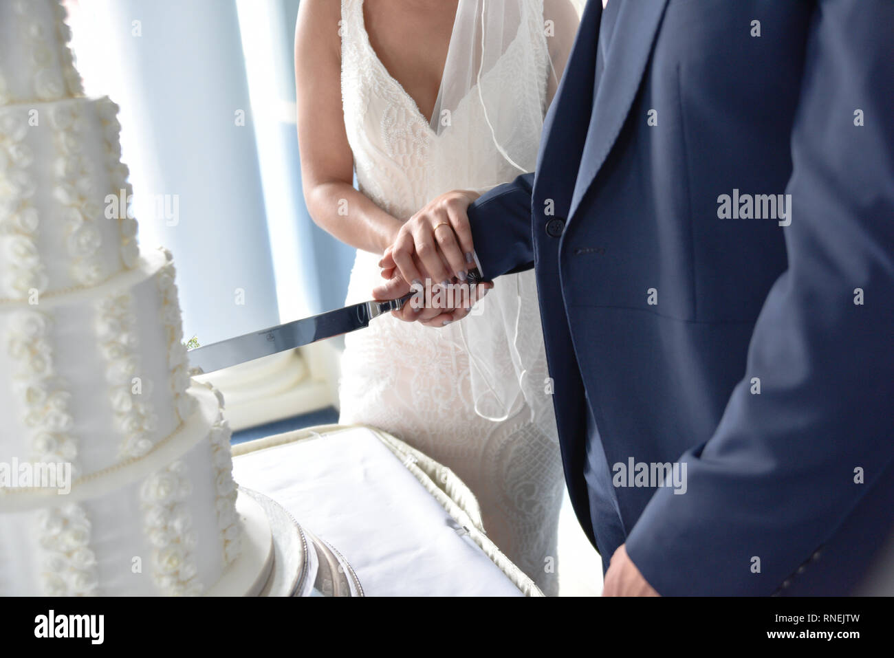 Beautiful white couple get married by the sea on a glorious Summer day ...