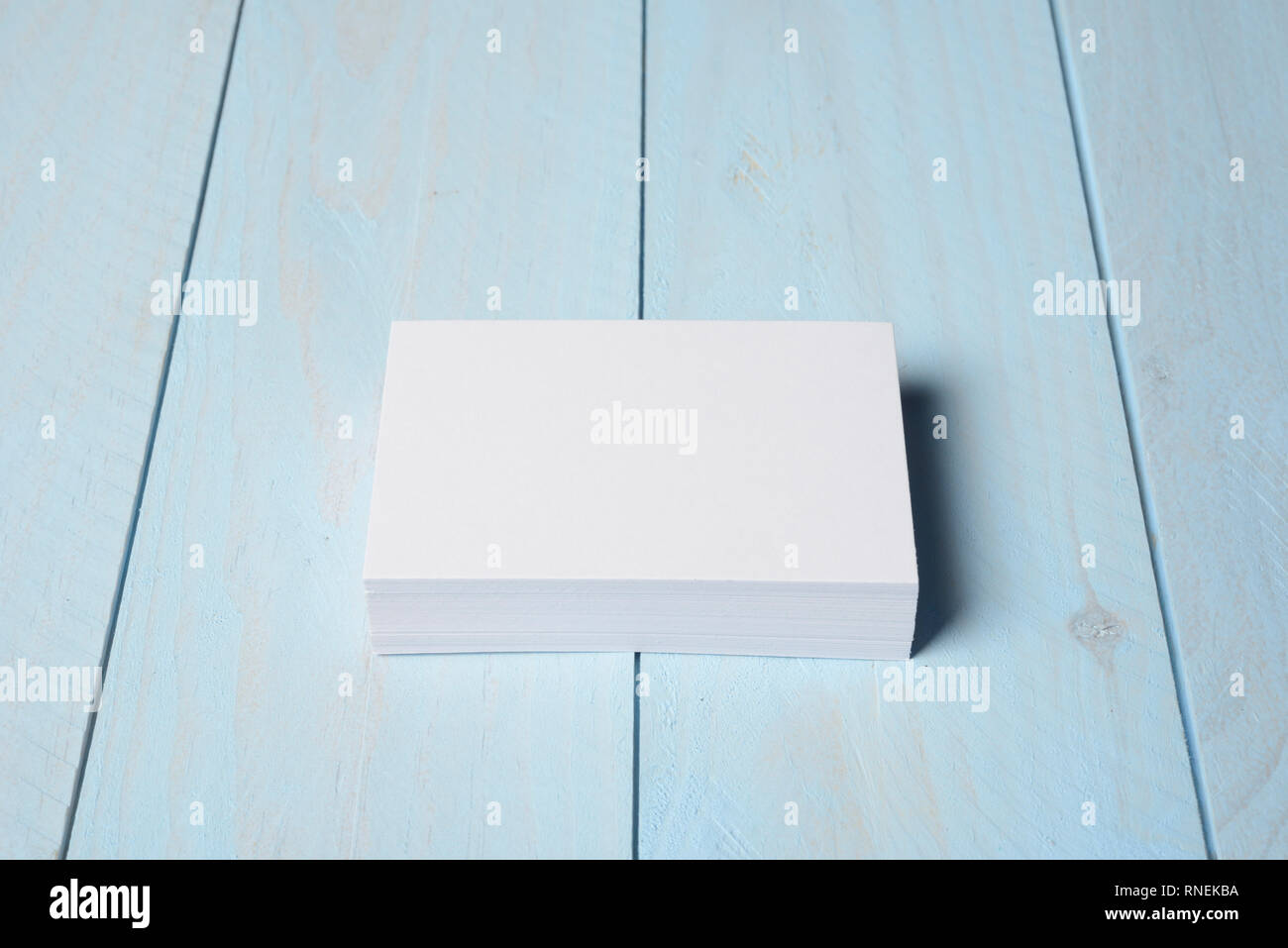 Pile of blank cards on blue table Stock Photo - Alamy