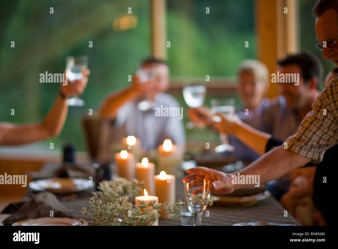 Family making a toast at dinner table Stock Photo - Alamy