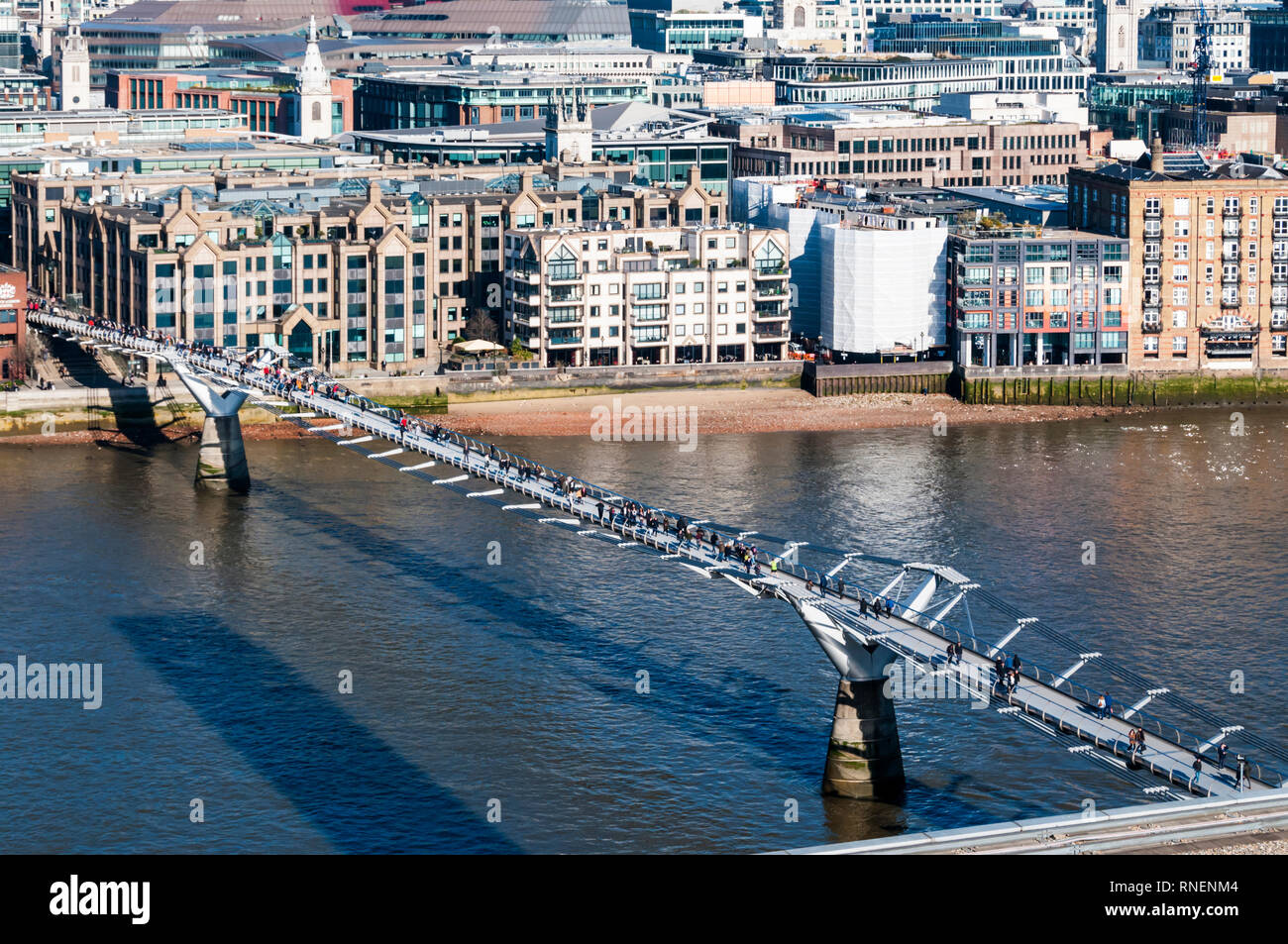 An elevated view of The Millennium Footbridge across the River Thames ...