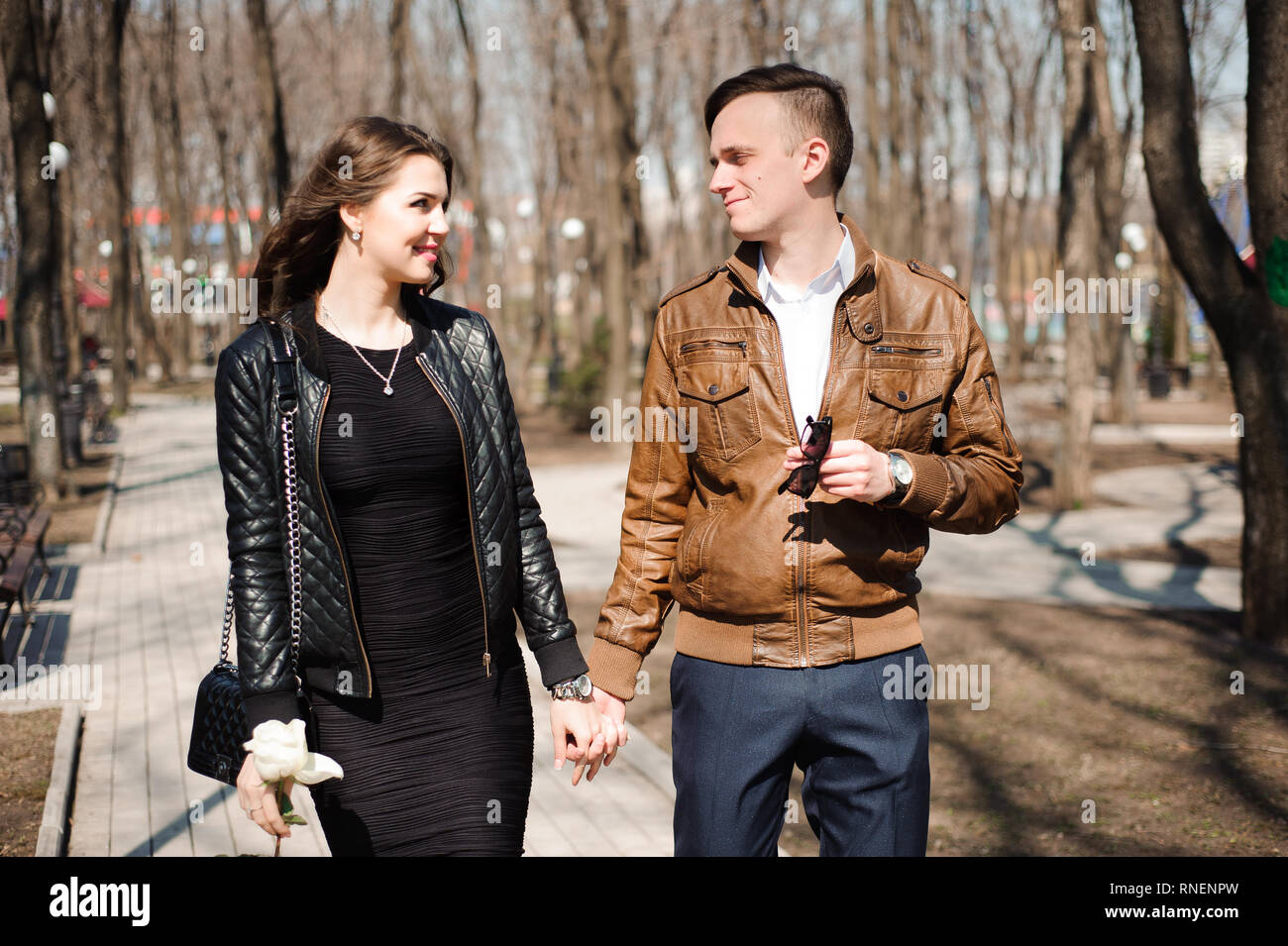 Portrait of young couple in love in a park Stock Photo - Alamy