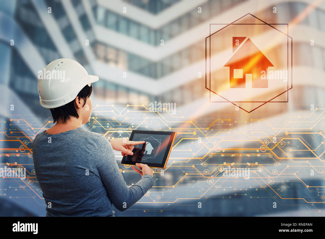 Woman construction engineer, wearing protective helmet, using tablet ...