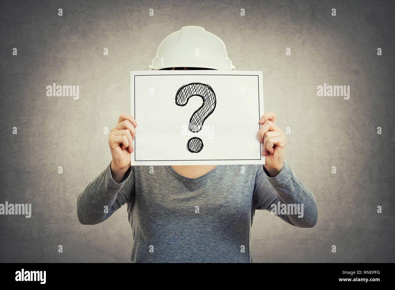 Anonymous young woman engineer wearing protective helmet, covering her ...