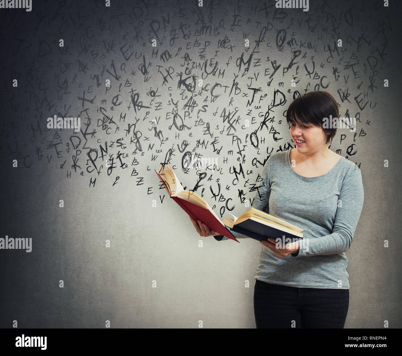 Woman student or teacher holding two open books and different letters ...