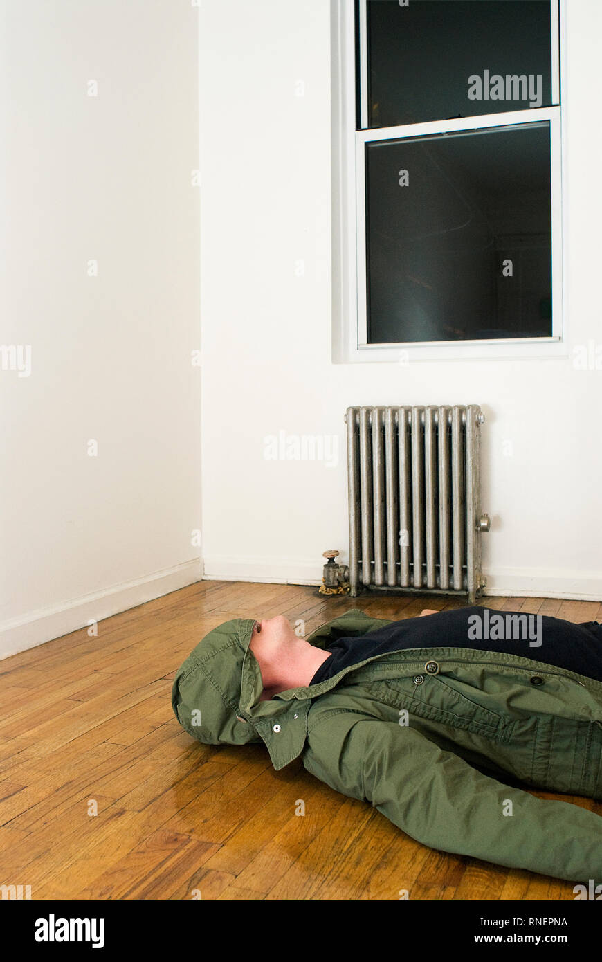 A man laying on the floor in an empty apartment Stock Photo - Alamy