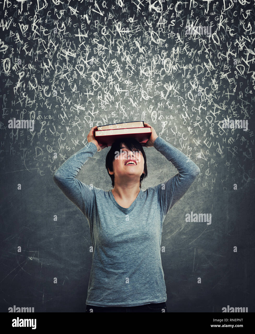 Woman student looking up scared, covering head with books as protection ...