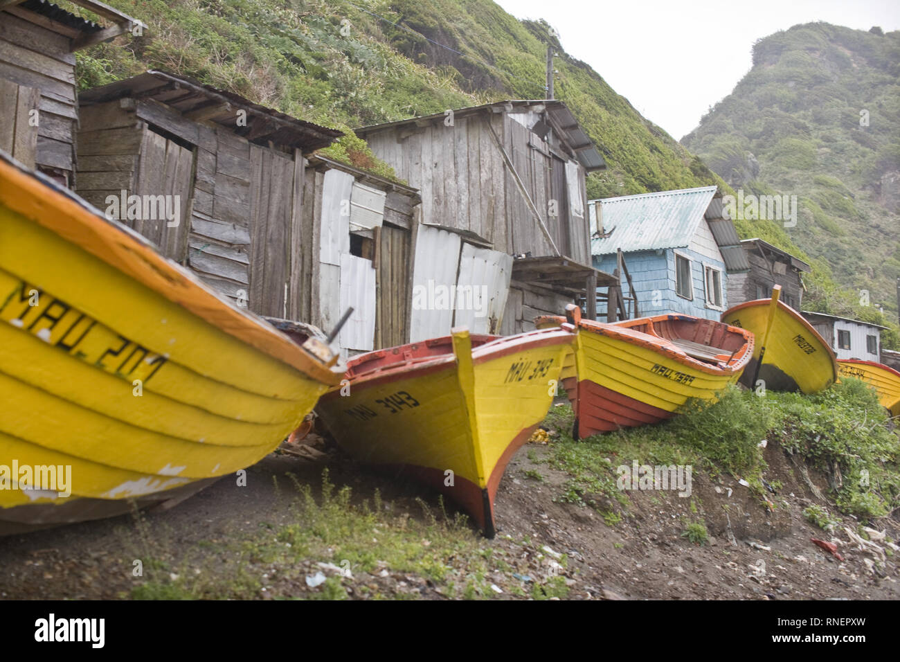 Old boats and a huts on a remote beach Stock Photo - Alamy
